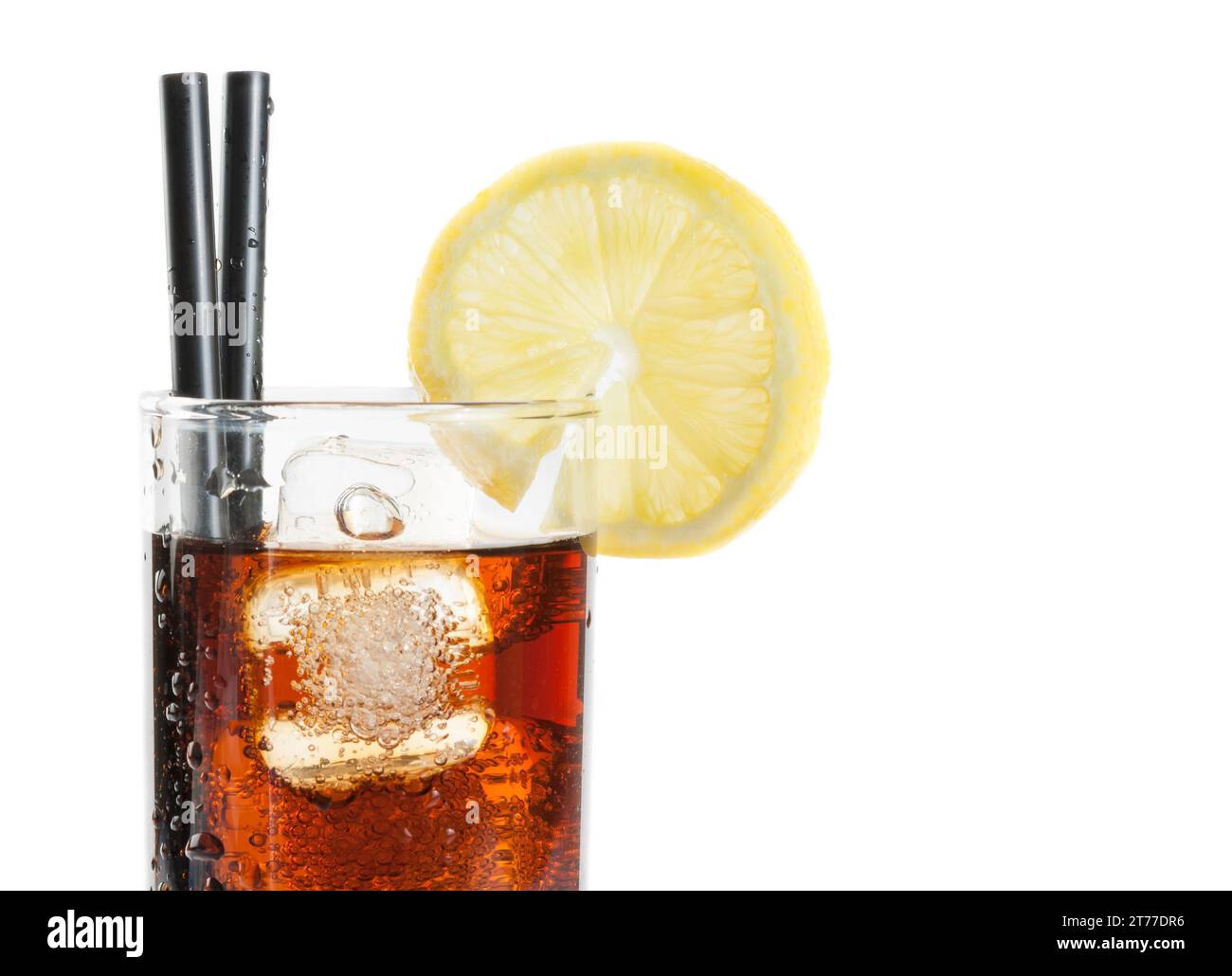 glass of fresh coke with straw with lemon slice on top and white ...