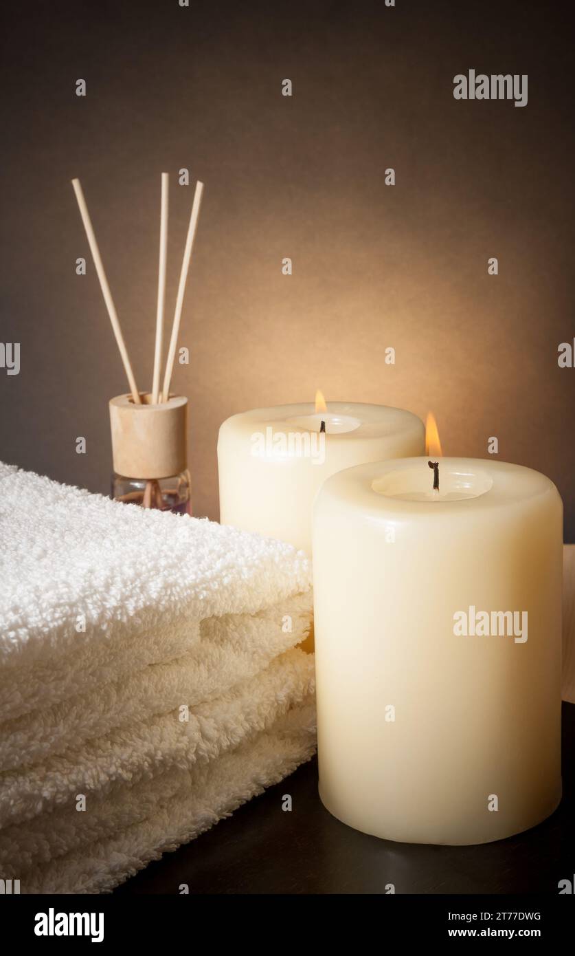 Spa massage border background with towel stacked and candles, with ...