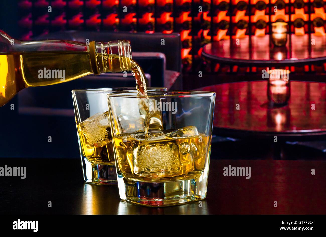 barman pouring whiskey in a lounge bar on wood table Stock Photo - Alamy