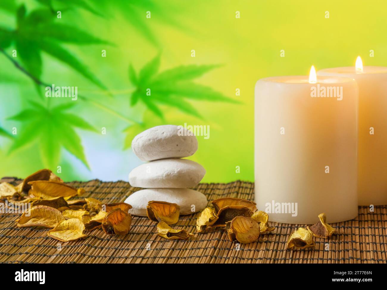 Spa massage border background with candle near stone and wood on bamboo ...