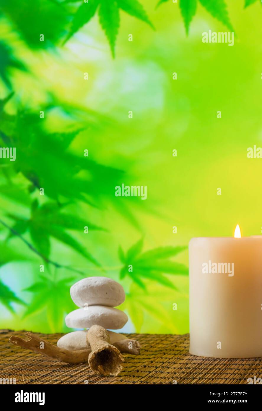 Spa massage border background with candle near stone and wood on bamboo ...