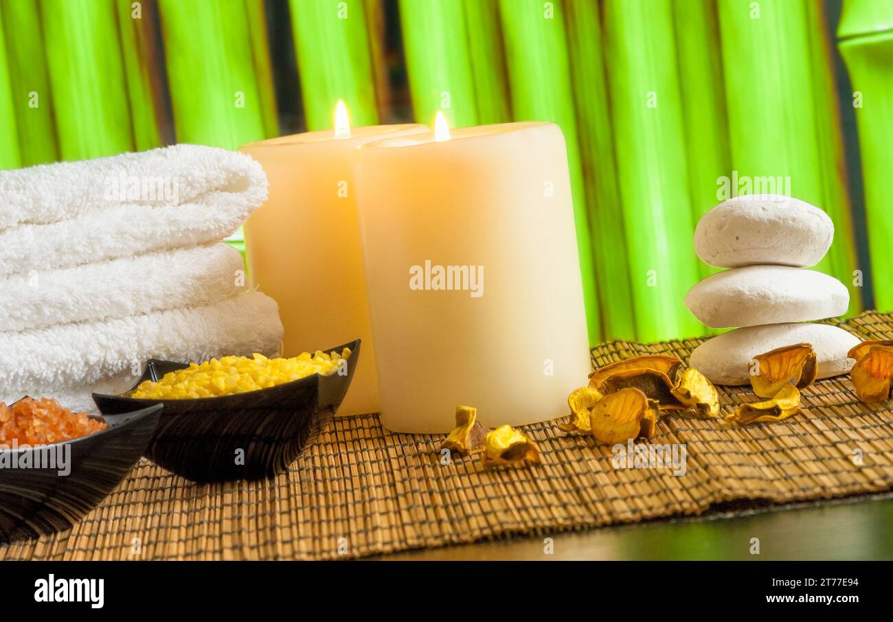 Spa massage border background with towel stacked, candles and sea salt ...