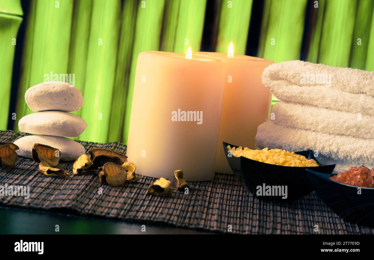 Spa massage border background with towel stacked, candles and sea salt ...