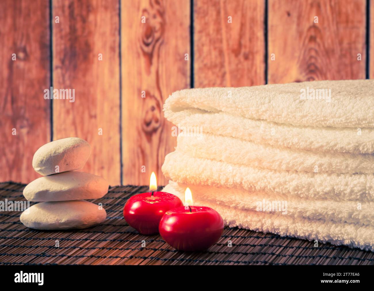 Spa massage border background with towel stacked stone and red candles ...