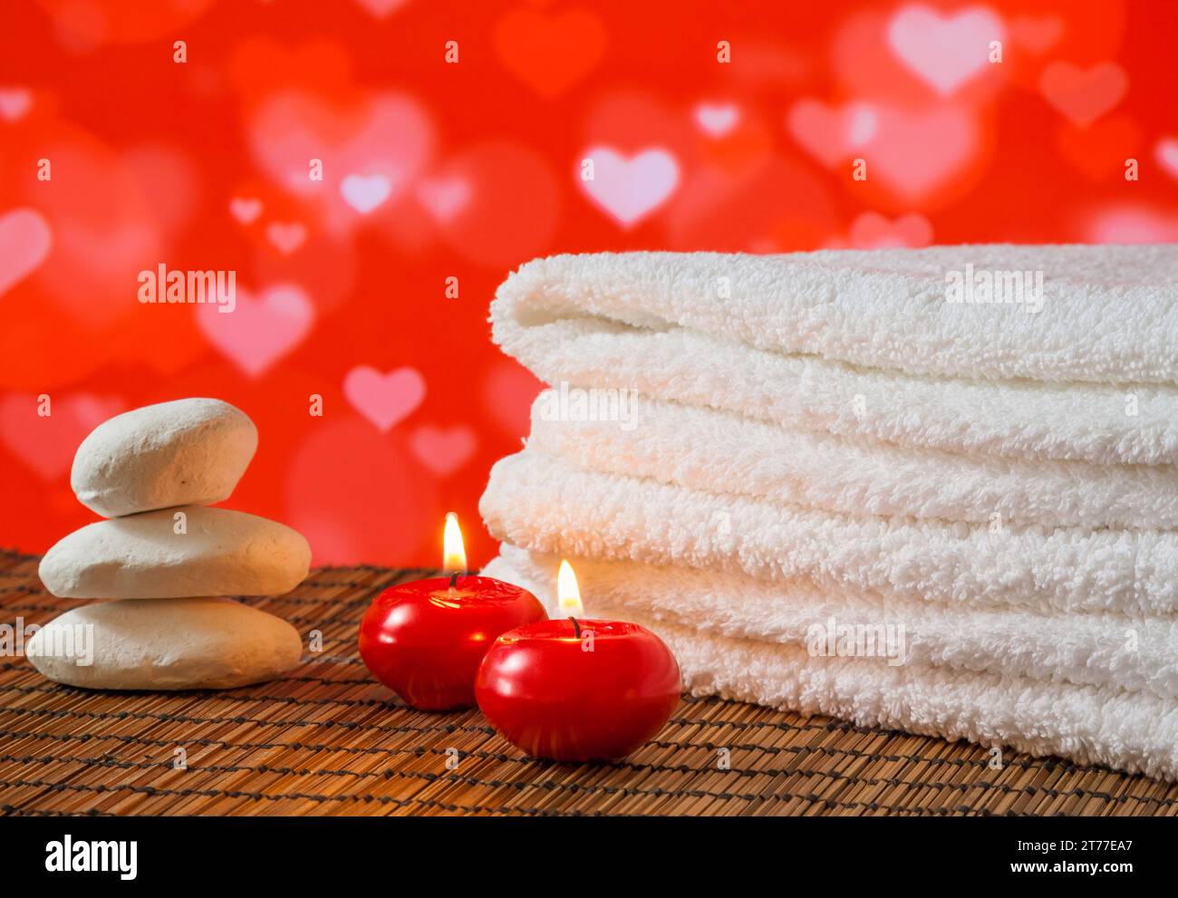 Spa massage border with towel stacked,red candles and stone on hearths ...