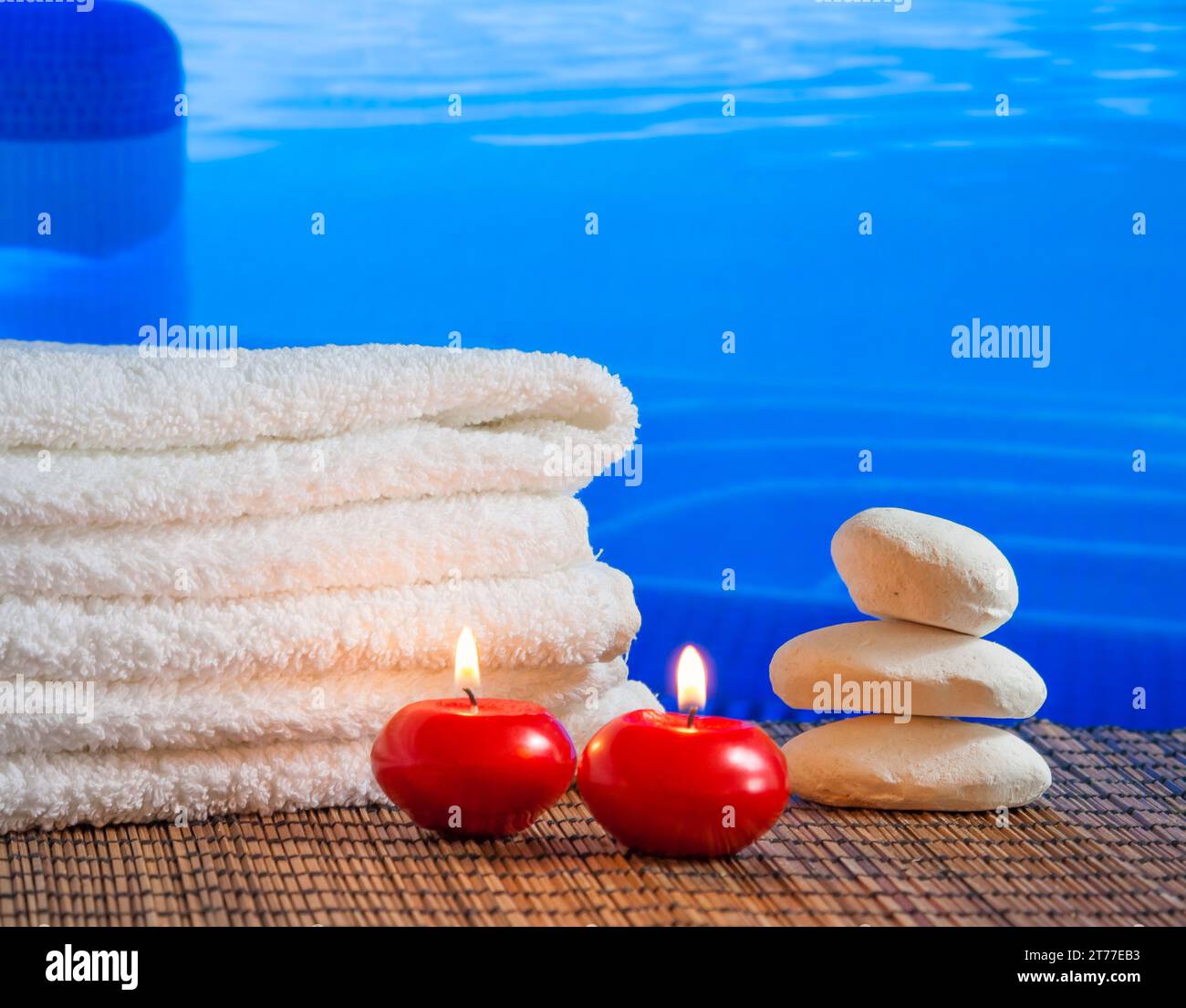 Spa massage border background with towel stacked,red candles and stone ...