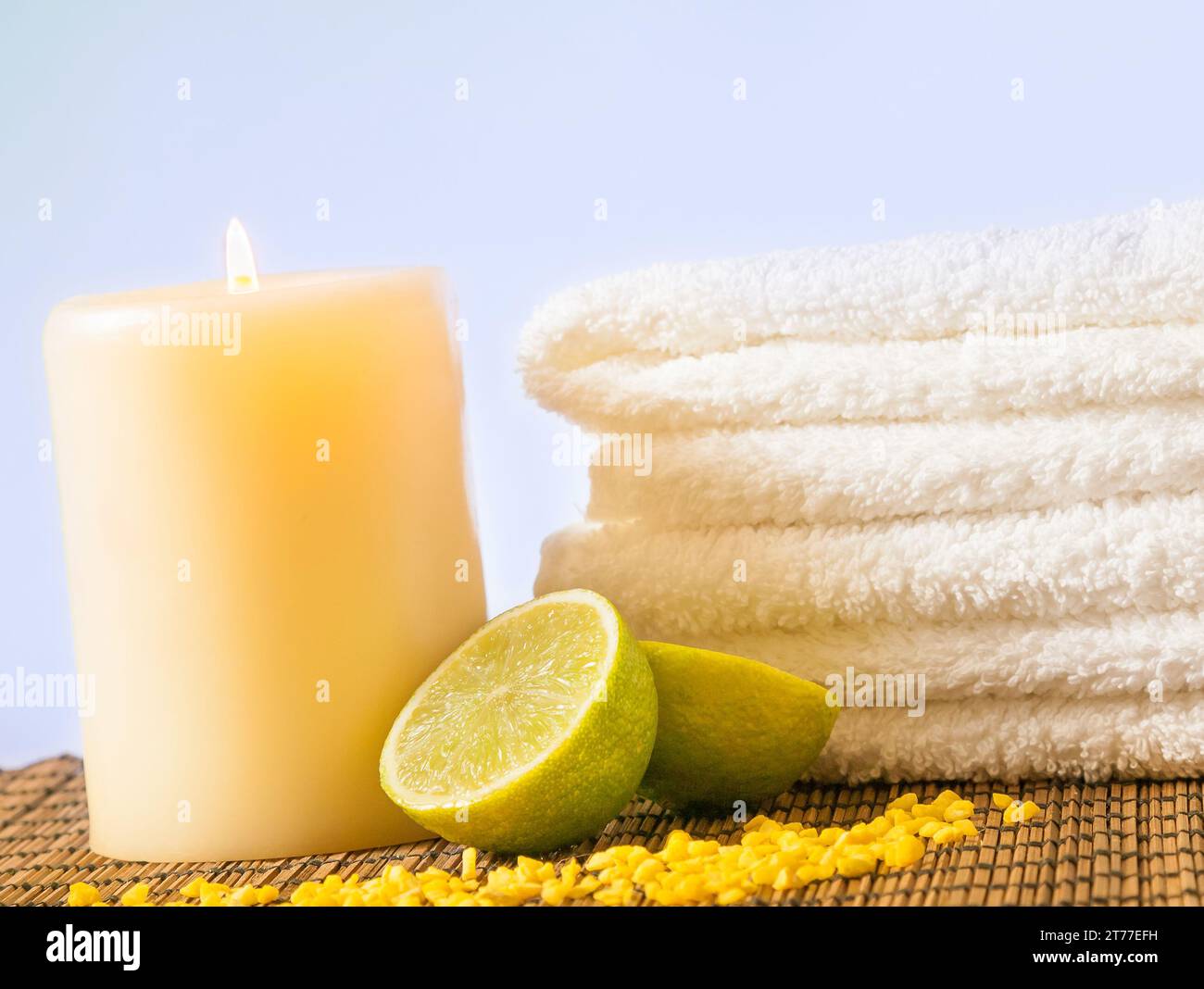 Spa massage border background with towel stacked and lime on light blue ...