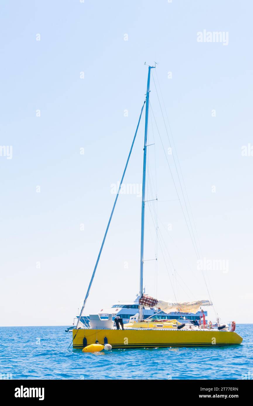 yellow sailboat sailing sail blue Mediterranean sea ocean horizon Stock ...