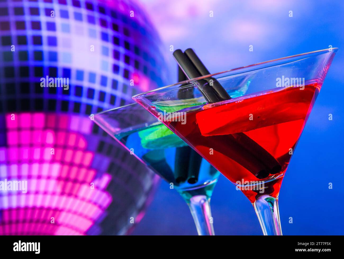 blue and red cocktail with sparkling disco ball background with space ...