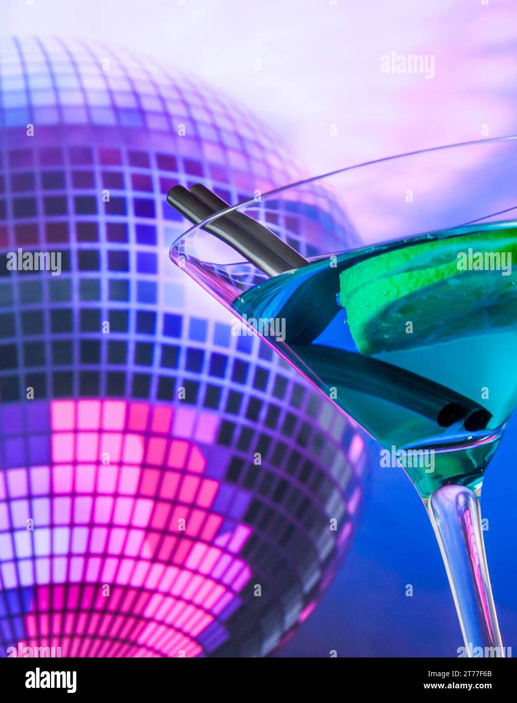blue cocktail with sparkling disco ball background with space for text ...