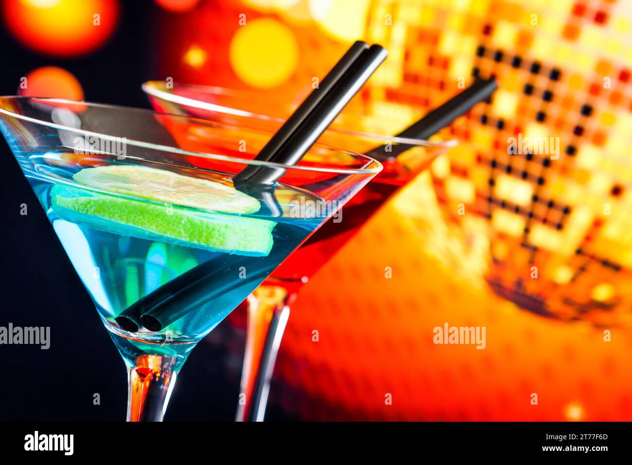 blue and red cocktail with sparkling disco ball background with space ...