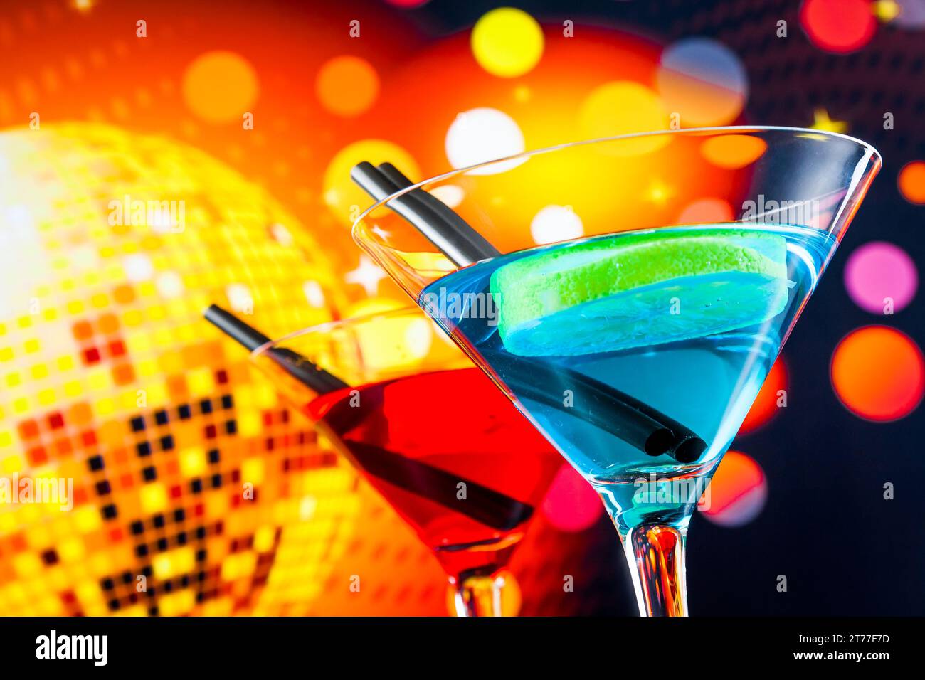 red and blue cocktail with sparkling disco ball background with space ...