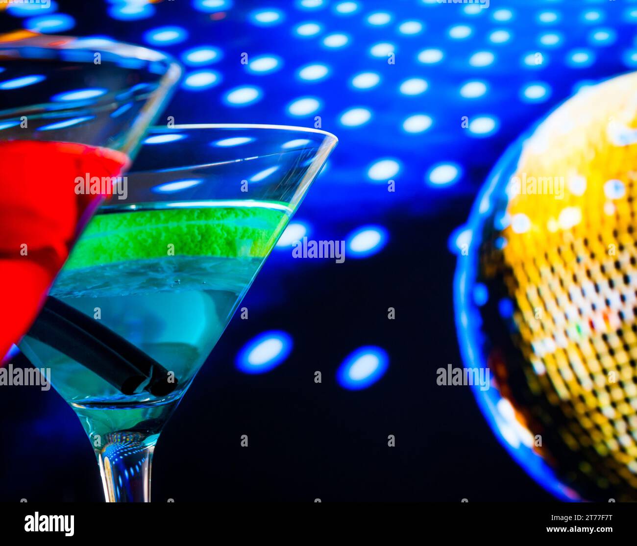 blue and red cocktail with golden sparkling disco ball background ...