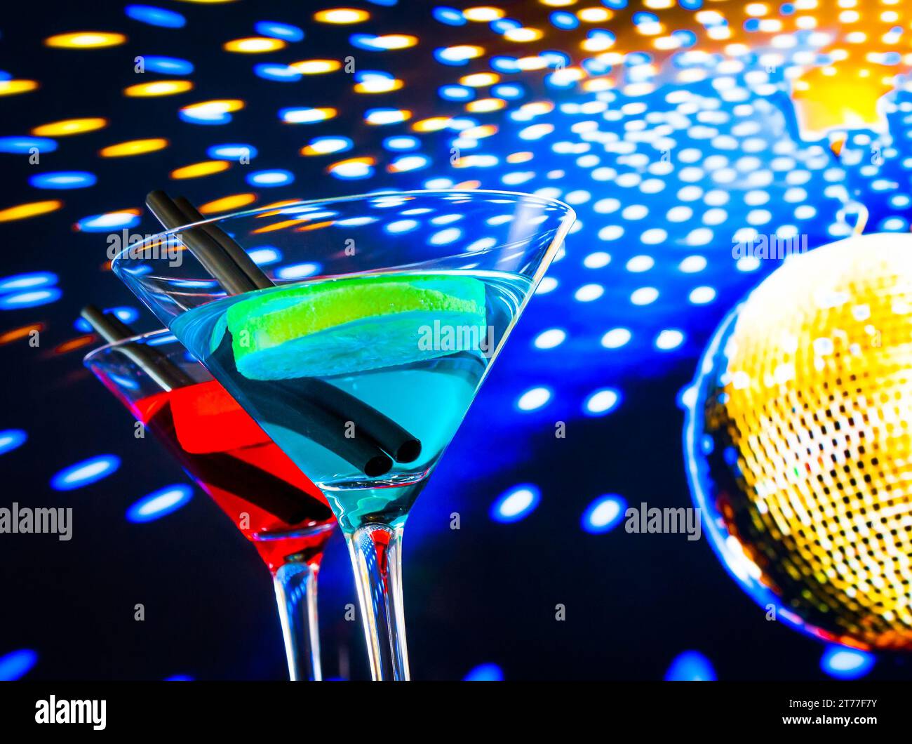 blue and red cocktail with golden sparkling disco ball background with ...
