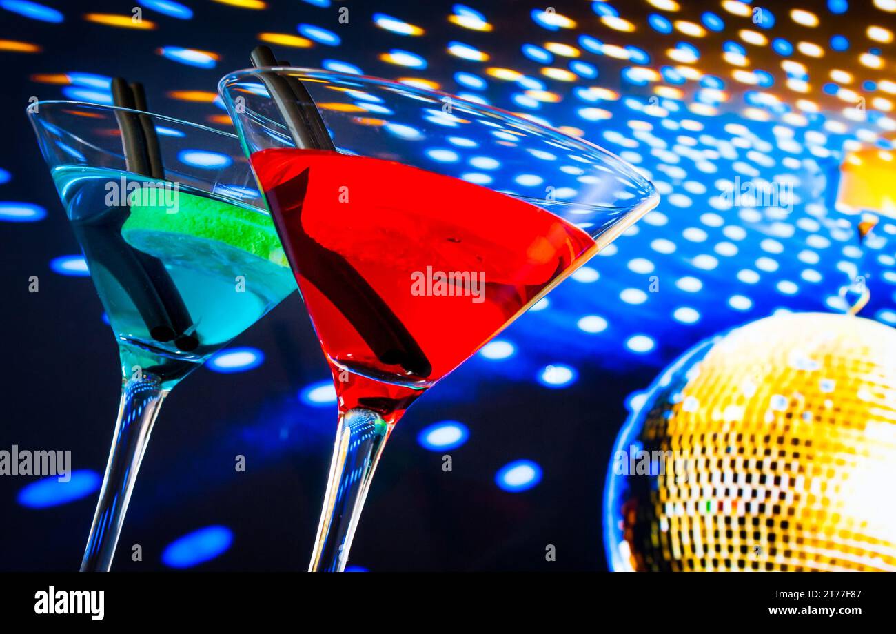 blue and red cocktail with golden sparkling disco ball background with ...