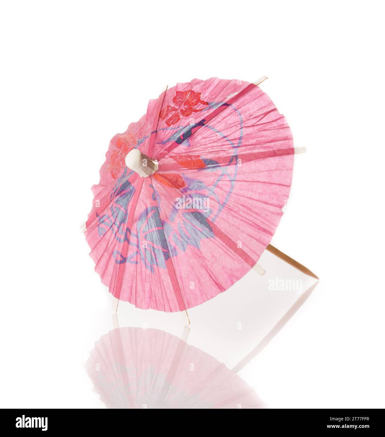 pink cocktail umbrella isolated against white background with ...