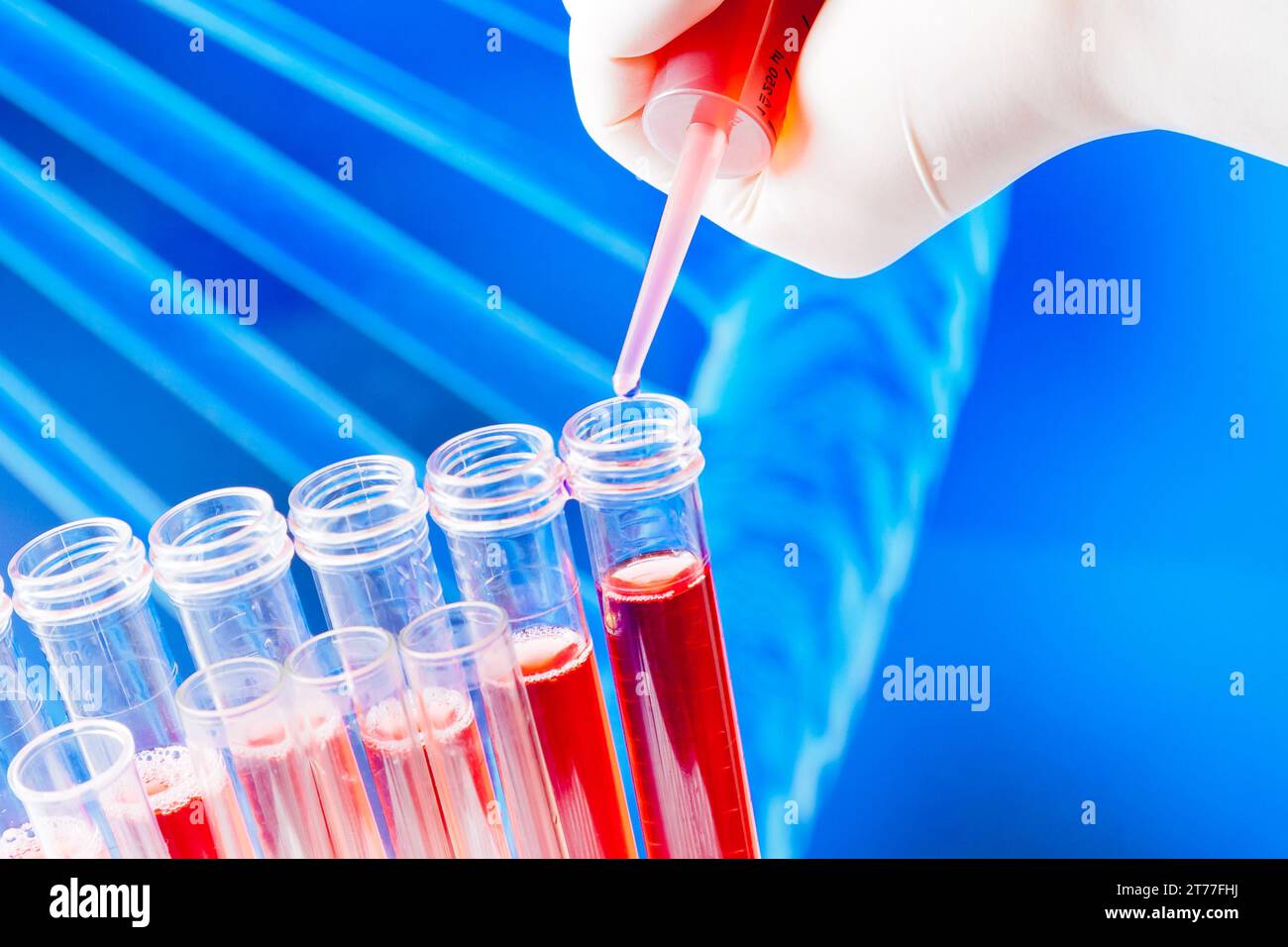 closeup of test tubes with pipette on red liquid on blue blur abstract ...