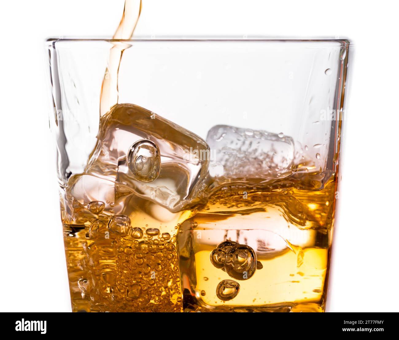 detail of pouring scotch whiskey in glass with ice cubes isolated on white background Stock ...