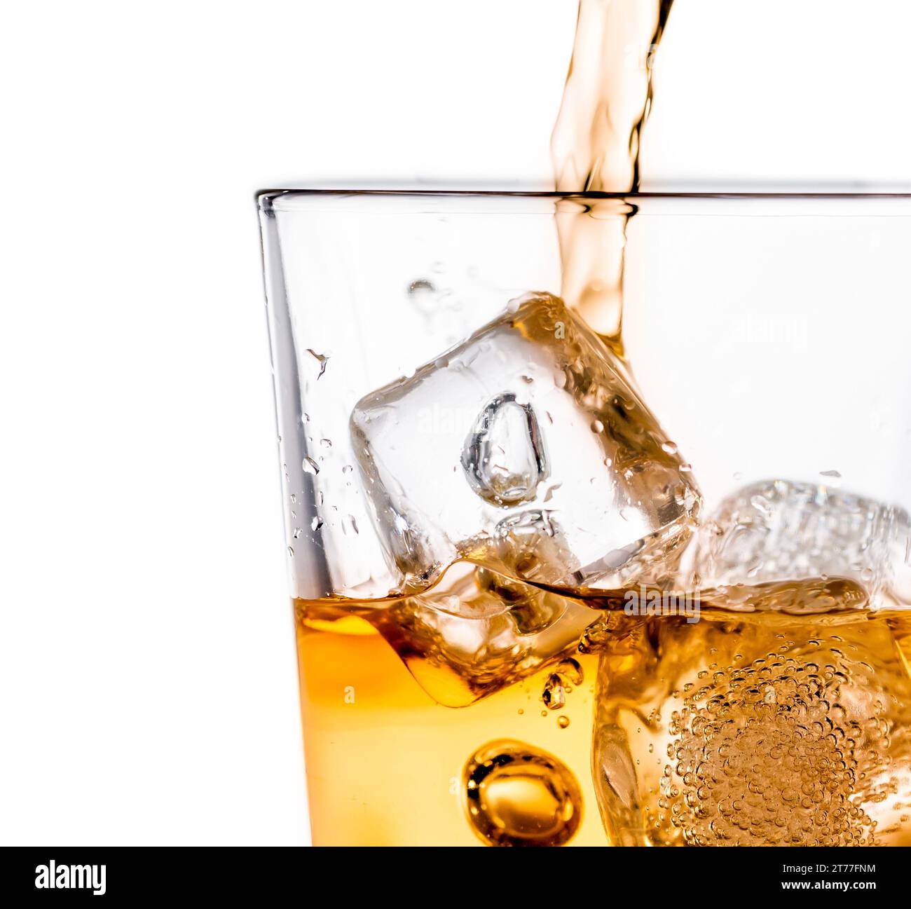 detail of pouring scotch whiskey in glass with ice cubes isolated on white background Stock ...