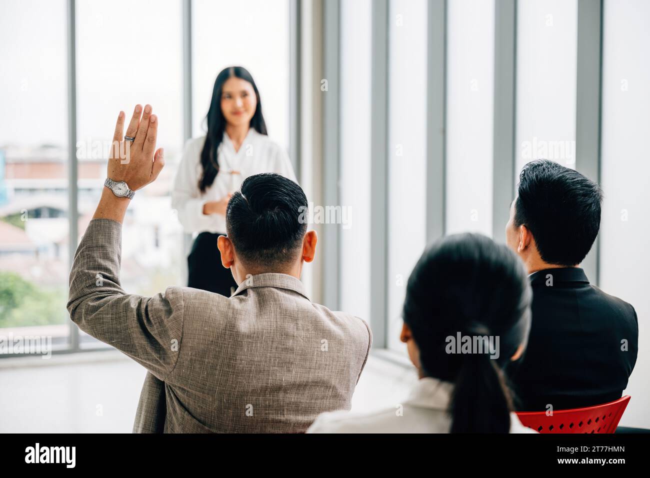 In a seminar classroom, a large group actively participates in the ...