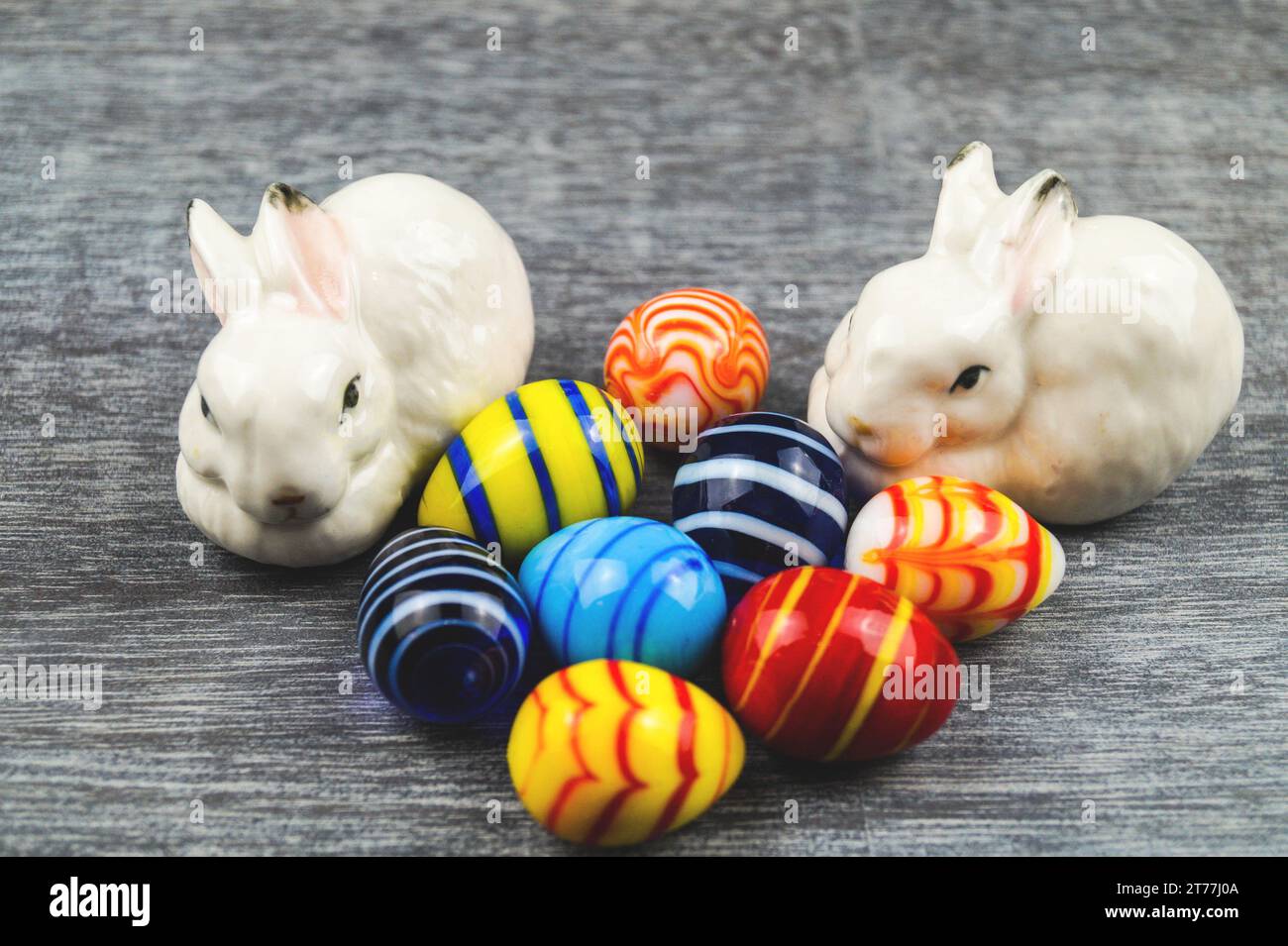 bunny figures with Easter eggs on gray Stock Photo - Alamy