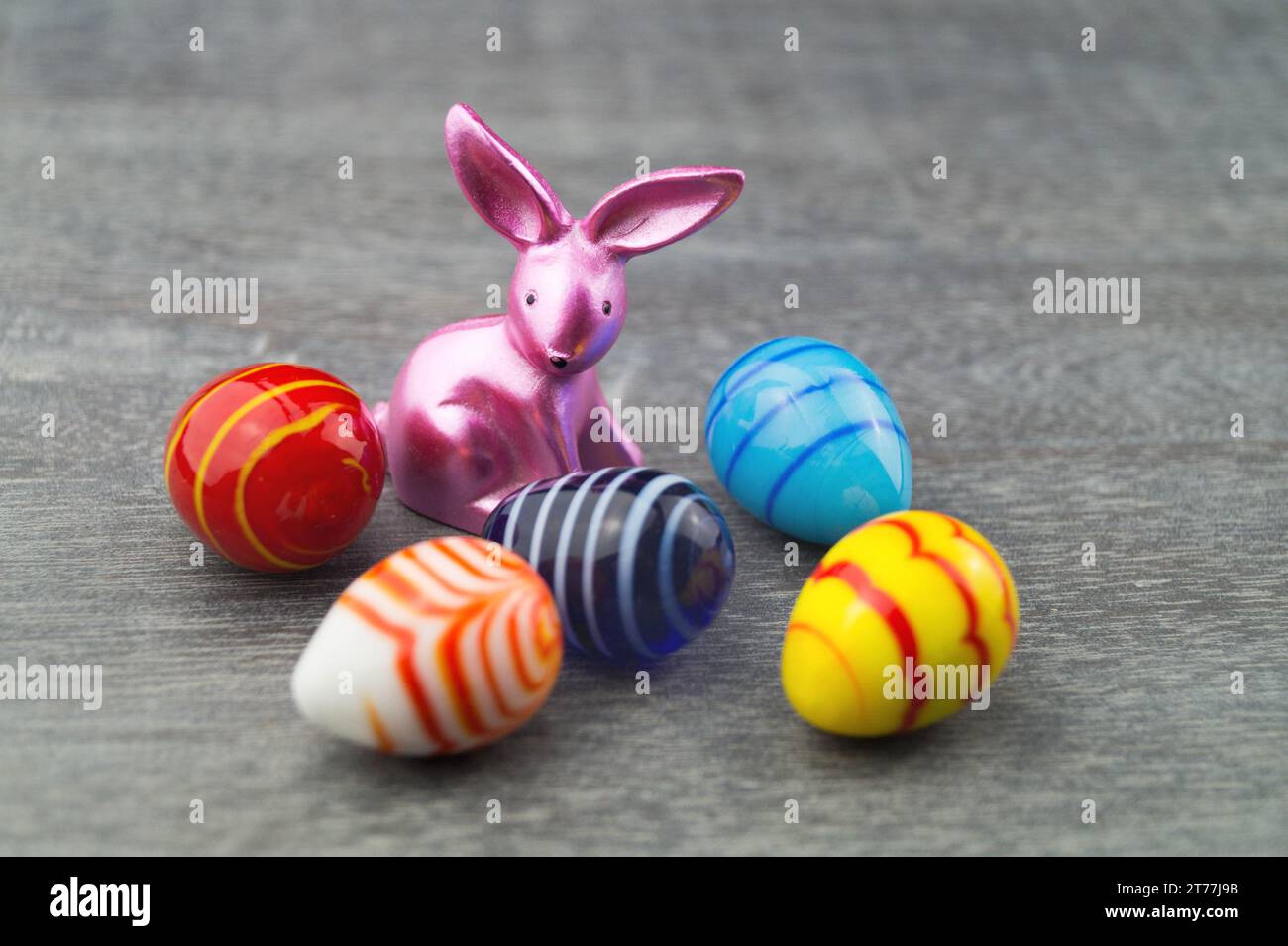 pink Easter bunny and Easter eggs on grey underground Stock Photo - Alamy