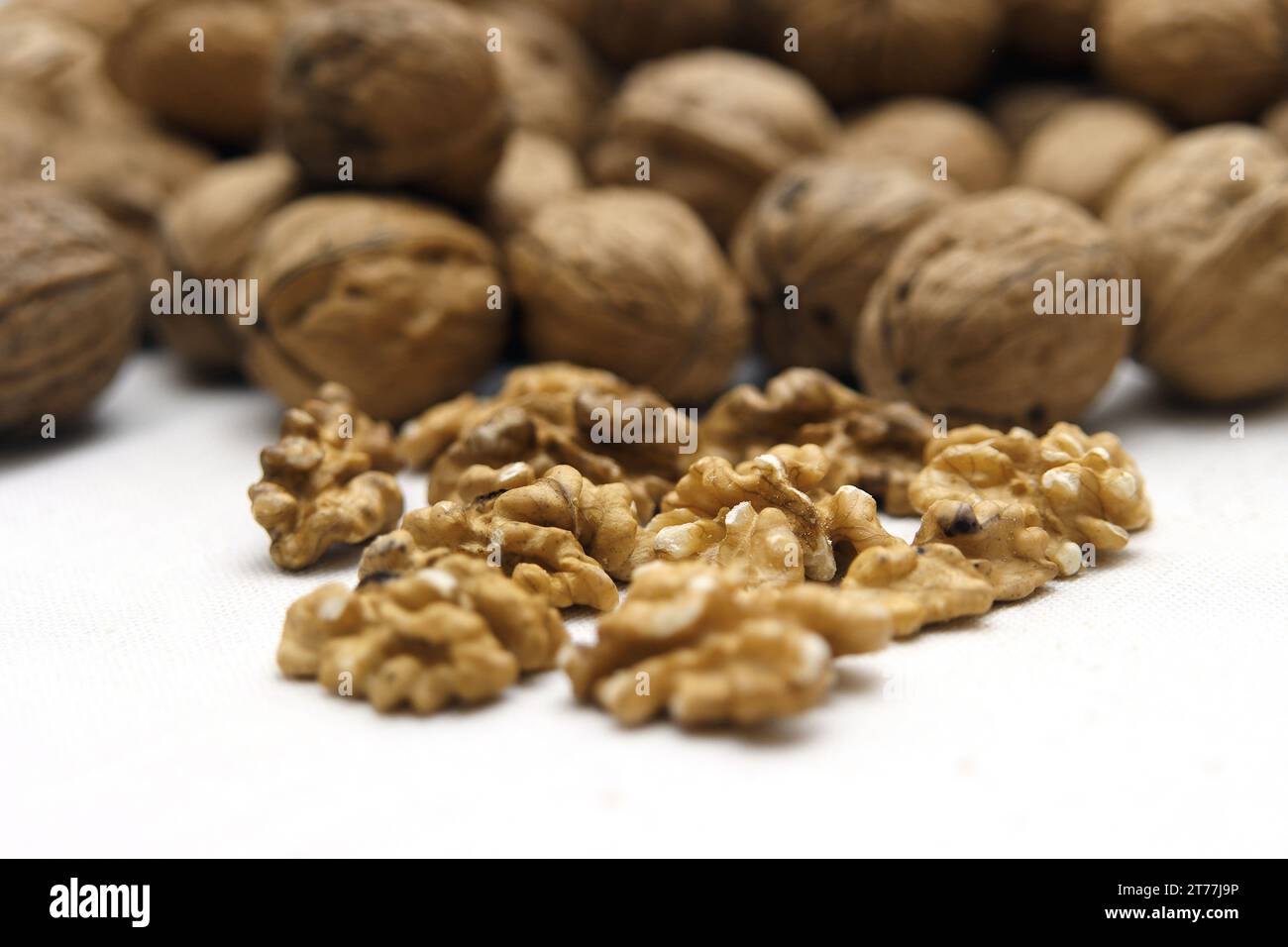 walnut (Juglans regia), collected and cracked walnuts Stock Photo - Alamy