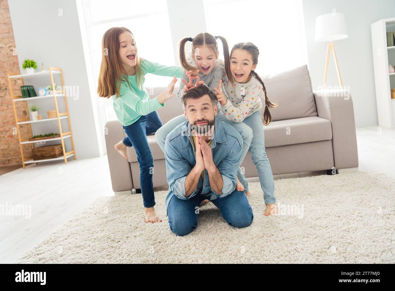 Portrait of attractive funny cheerful family playing alone daddy ...