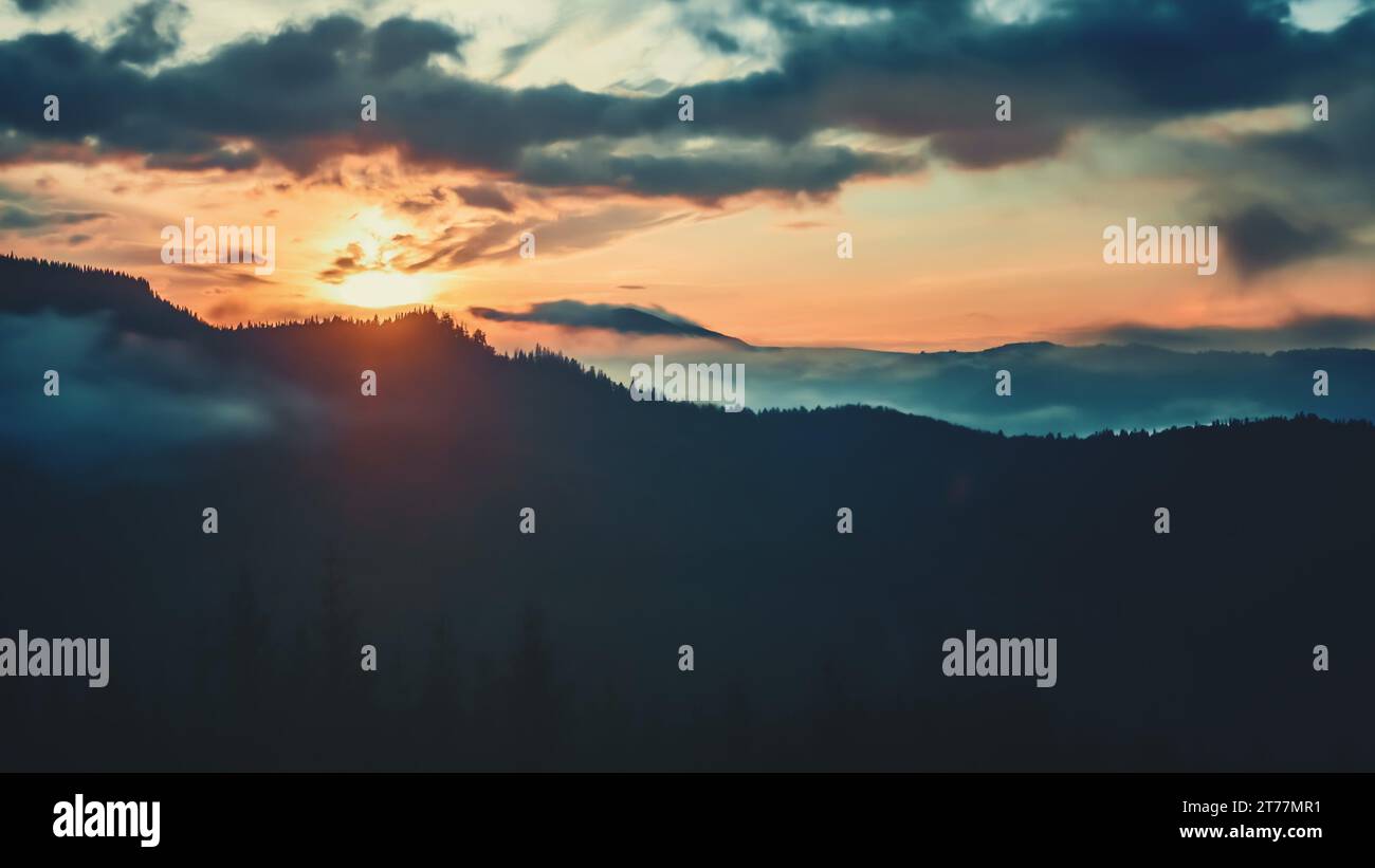 Epic foggy colorful sunrise in alp mountains. Dramatic clouds flow in ...