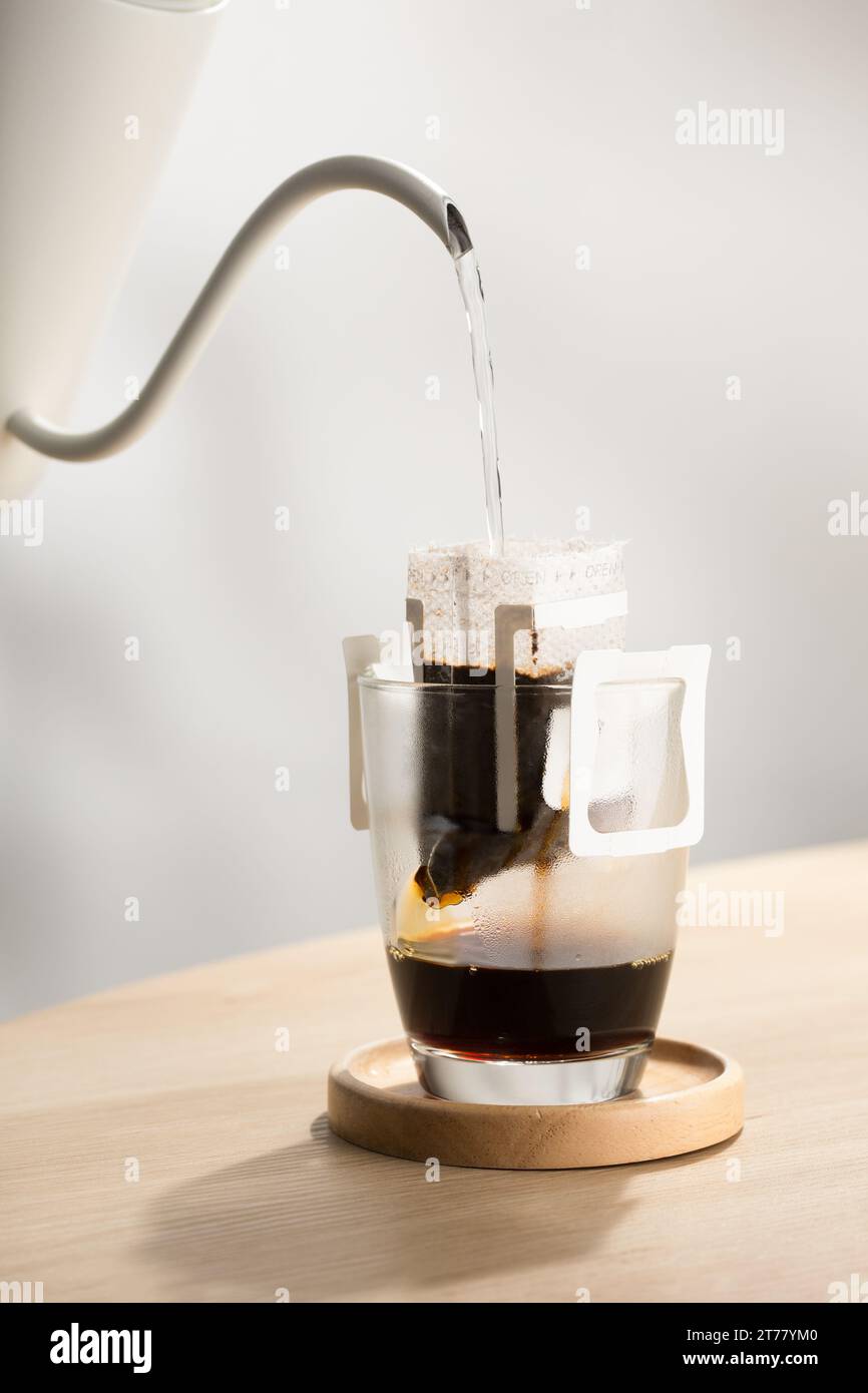 The hot water is poured over the roasted and ground coffee, in a filter ...