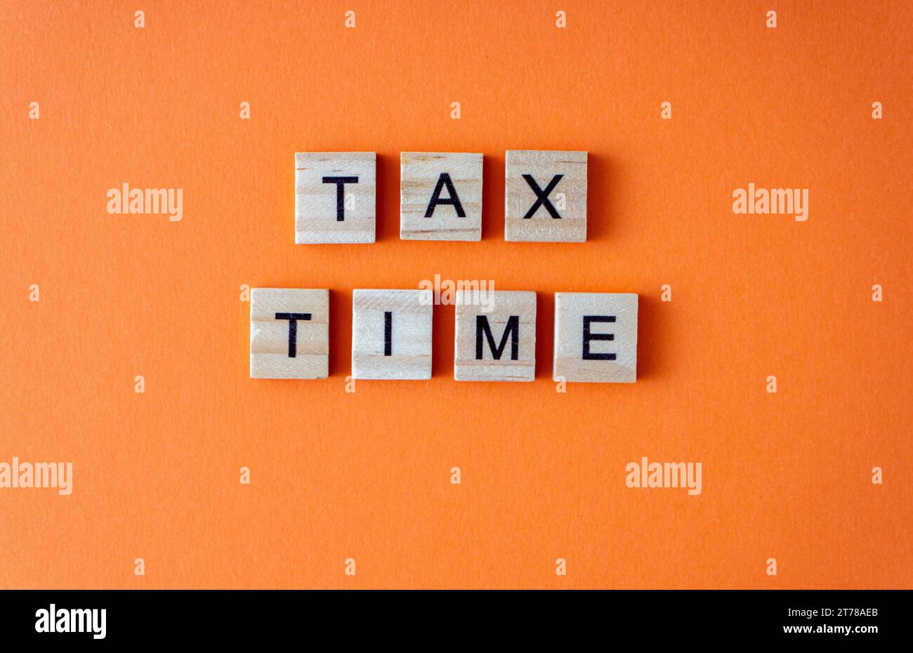 Word tax time. The phrase is laid out in wooden letters top view ...