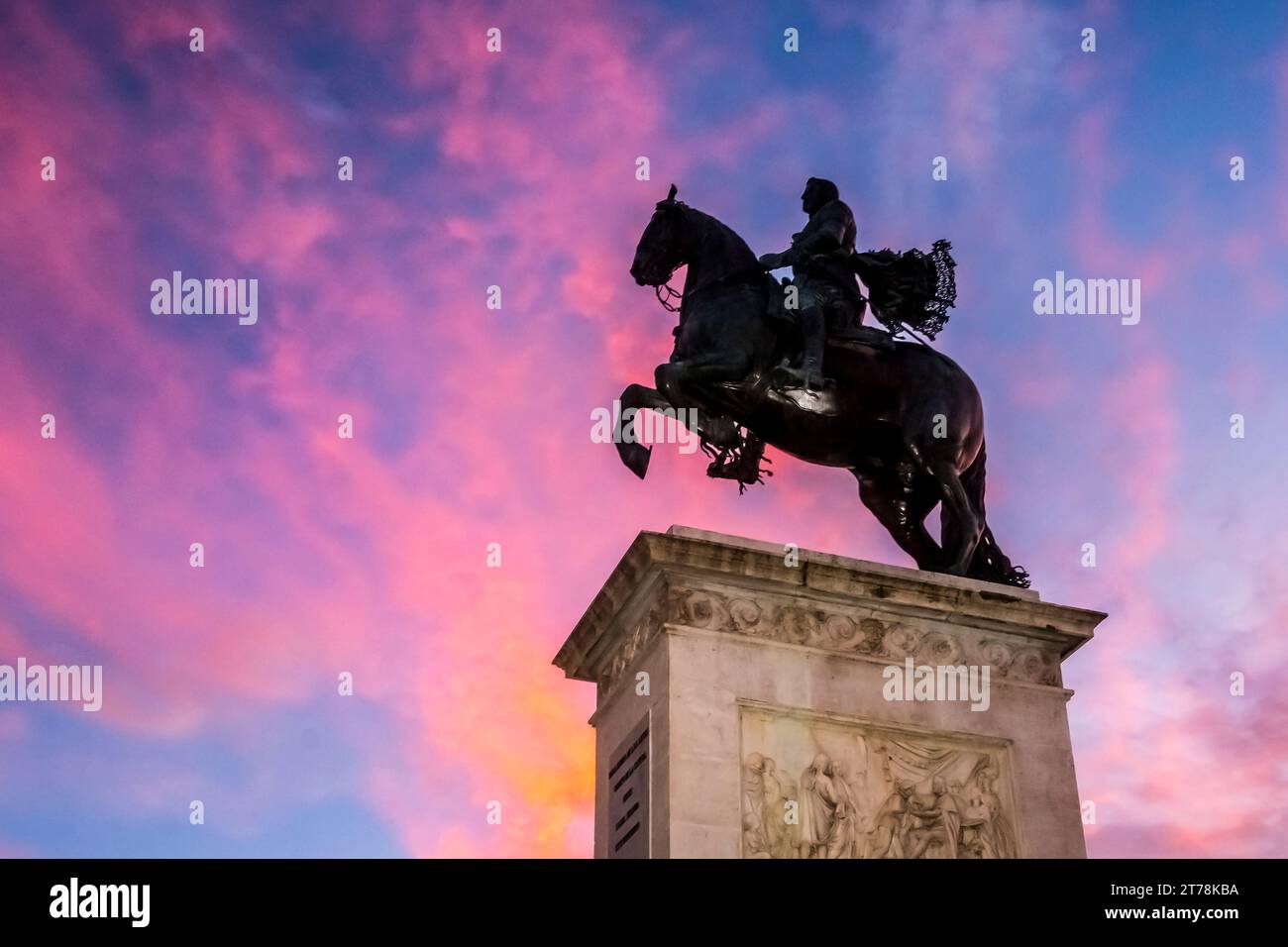 Silhouette of Felipe IV monument in Plaza de Oriente with dark blue sky ...
