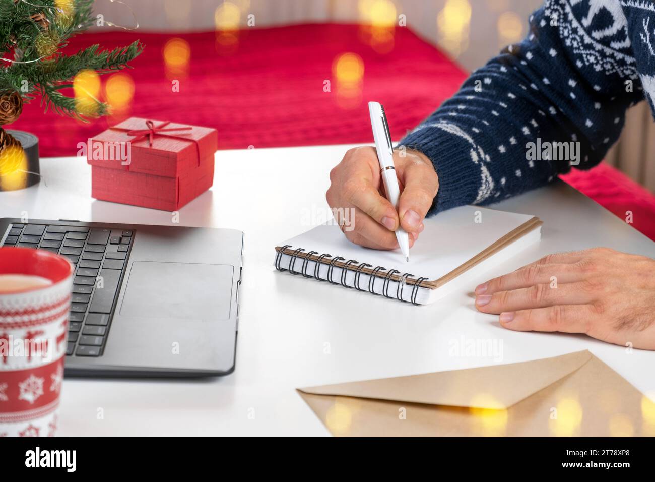 Writing a Christmas Wishing Card. Male adult making greeting cards at ...