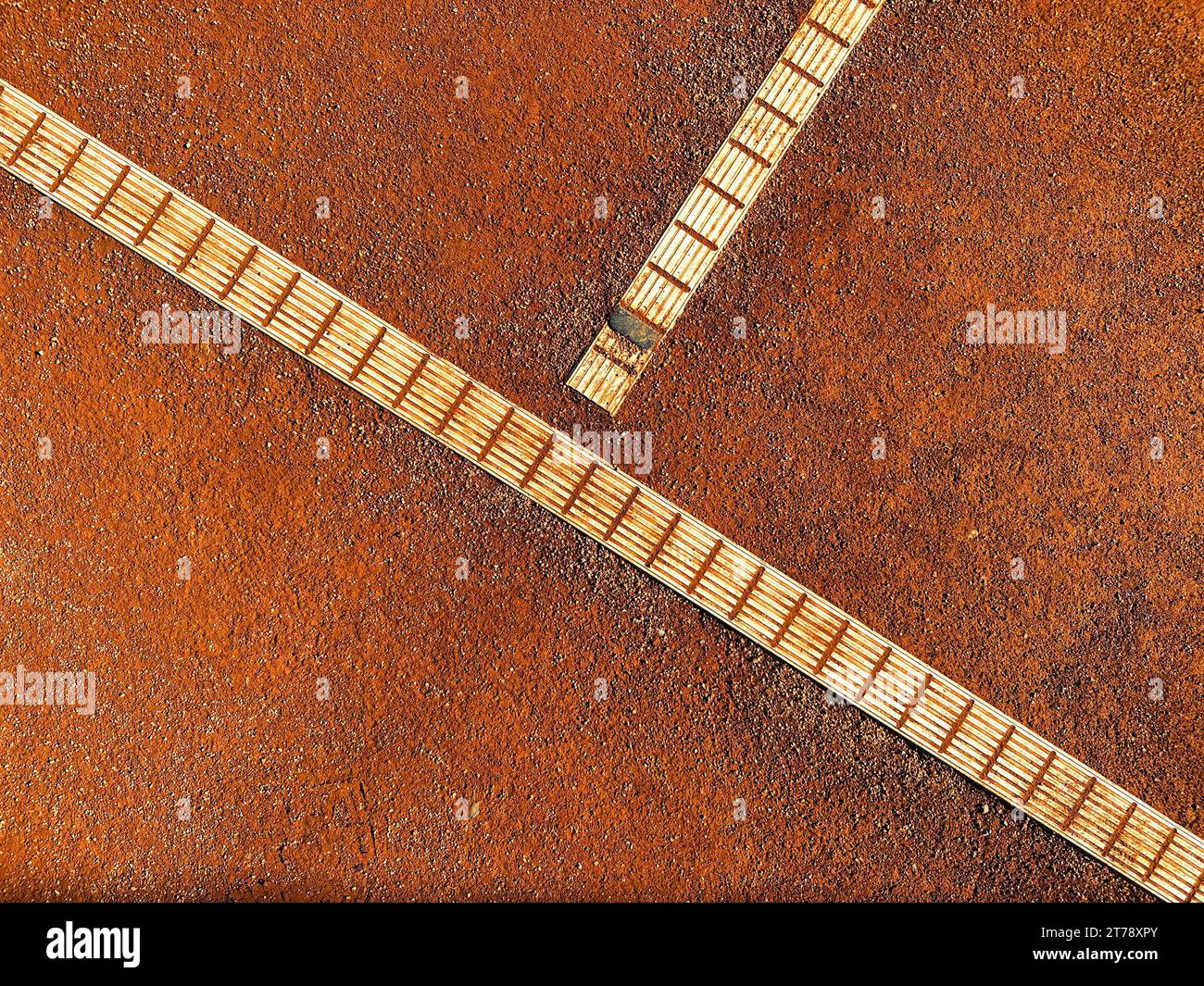 Aerial view of clay tennis court corner with white lines cross ...