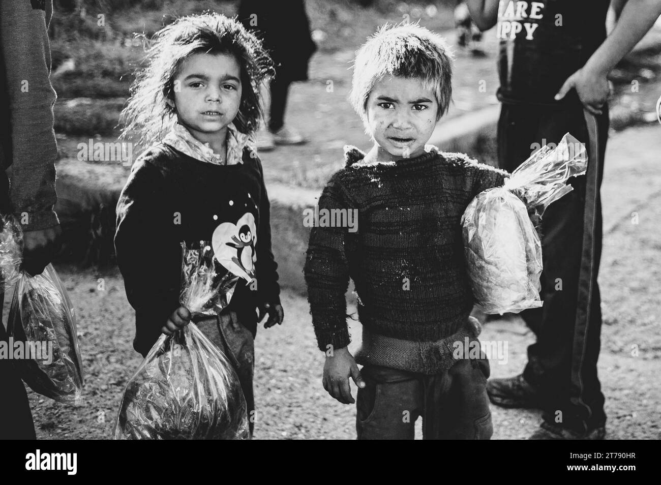 The poor gypsy kids getting bread from volunteers Stock Photo - Alamy
