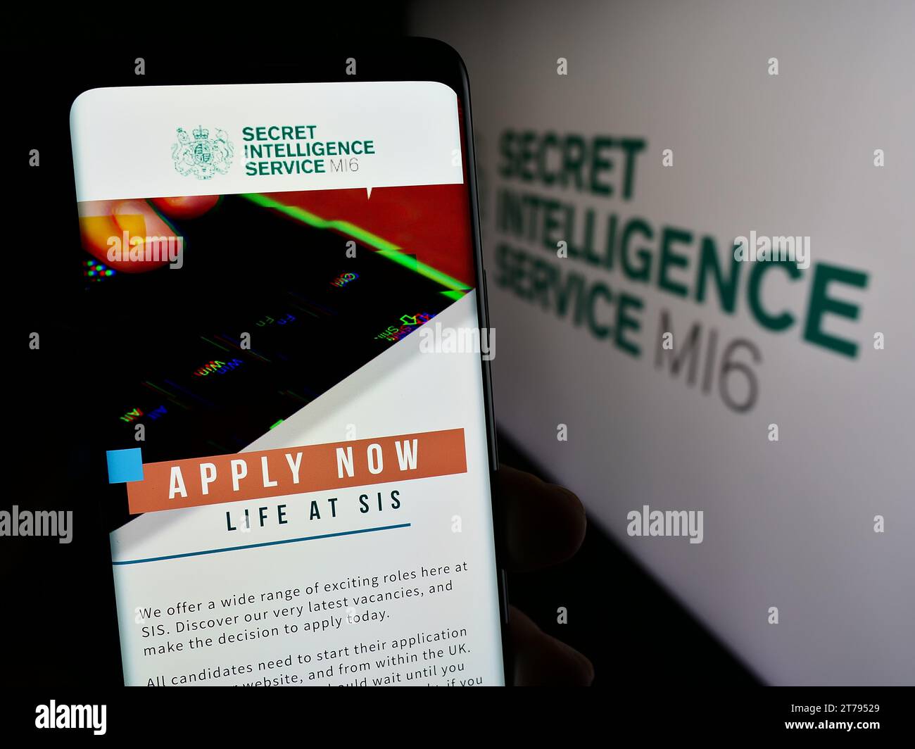Person holding cellphone with webpage of British agency Secret ...