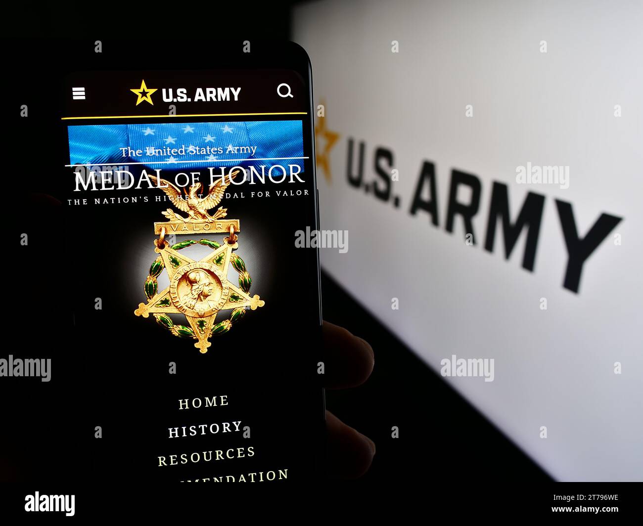 Person holding smartphone with Medal of Honor web page of United States ...