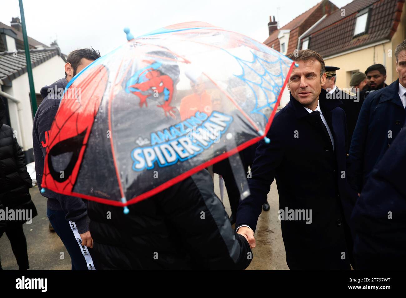 France's President Emmanuel Macron, shakes hands with a resident of ...