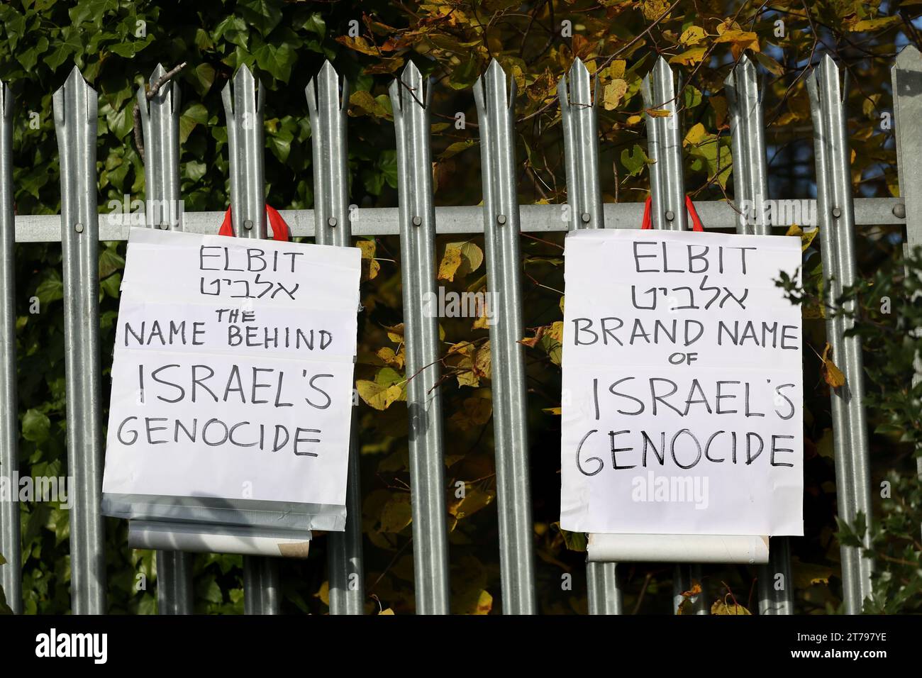 Signs are left on the railings by supporters outside court saying ...