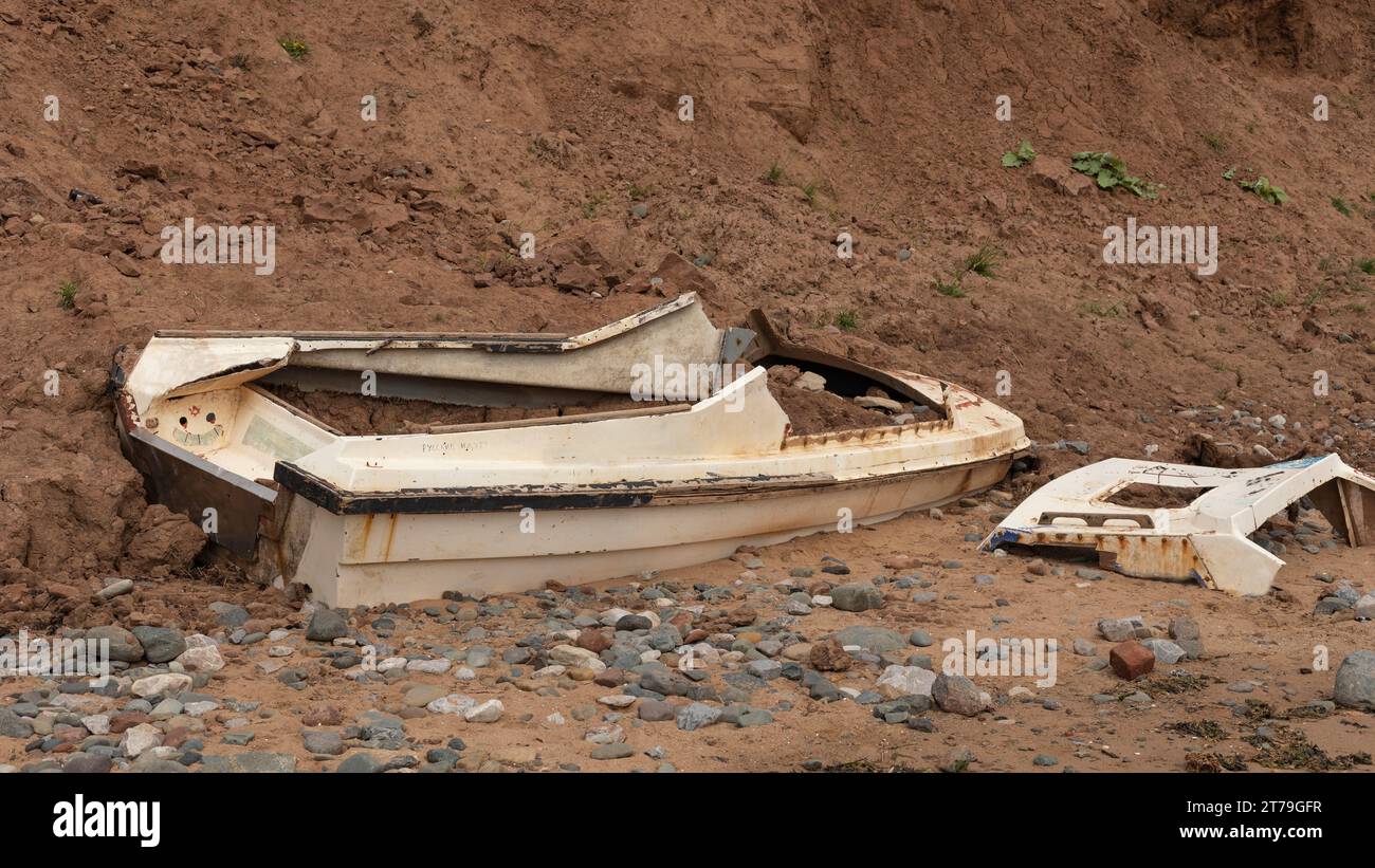 Ship wrecked boat washed ashore and embedded in the sand on the beach ...