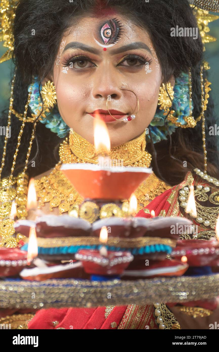 Portrait of beautiful Indian girl of Durga Idol Agomoni Concept Indoor ...