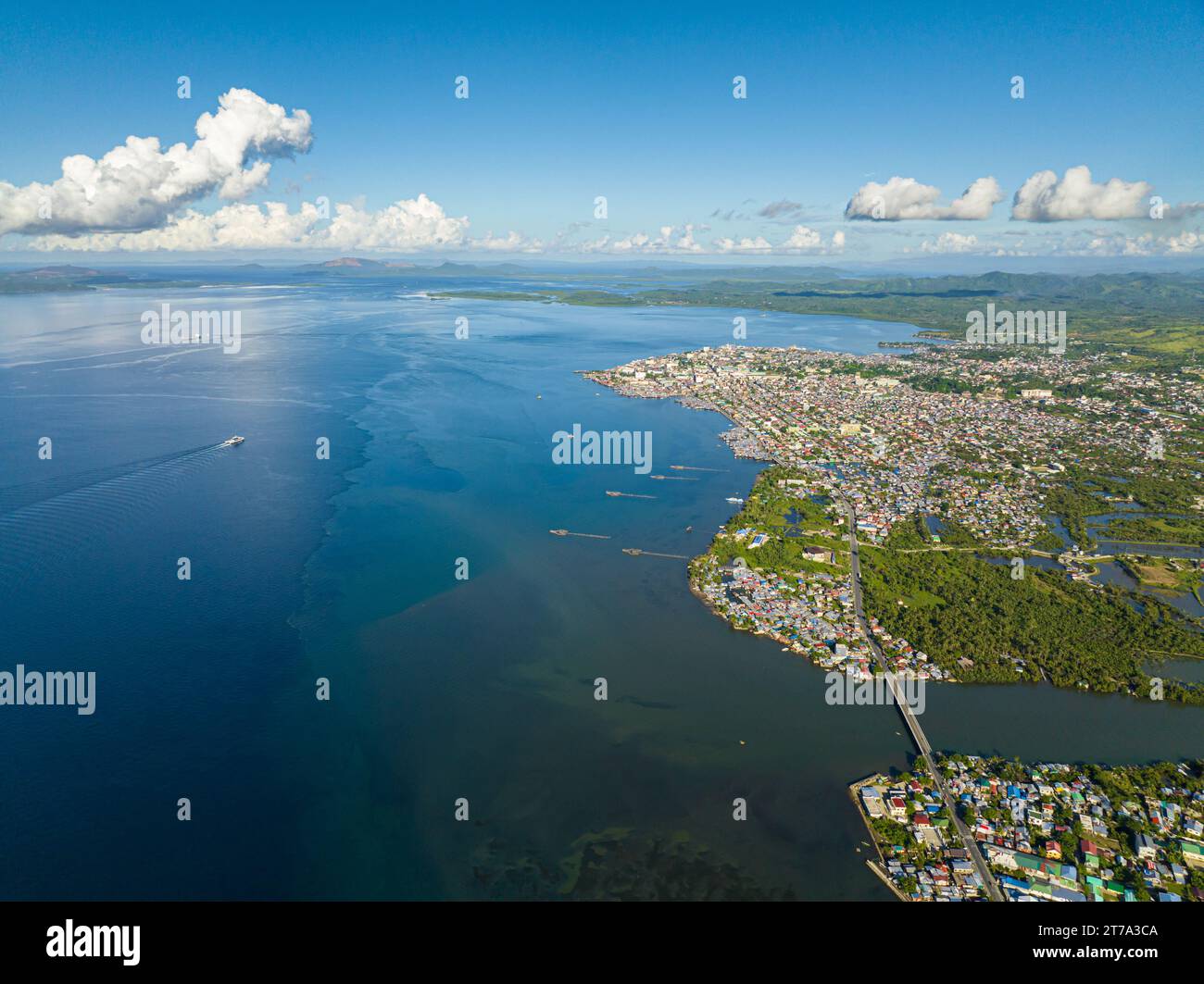 Aerial view of Surigao City with buildings and houses. Blue sea bay and ...