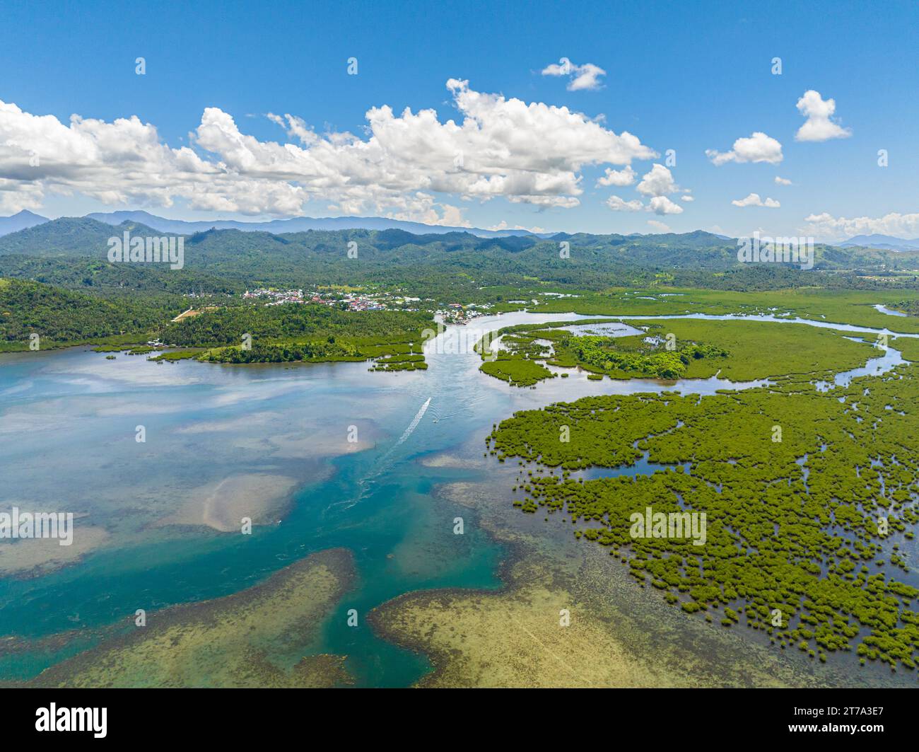 Aerial view of beautiful mangroves near the city town. Turquoise water and blue sky and clouds ...