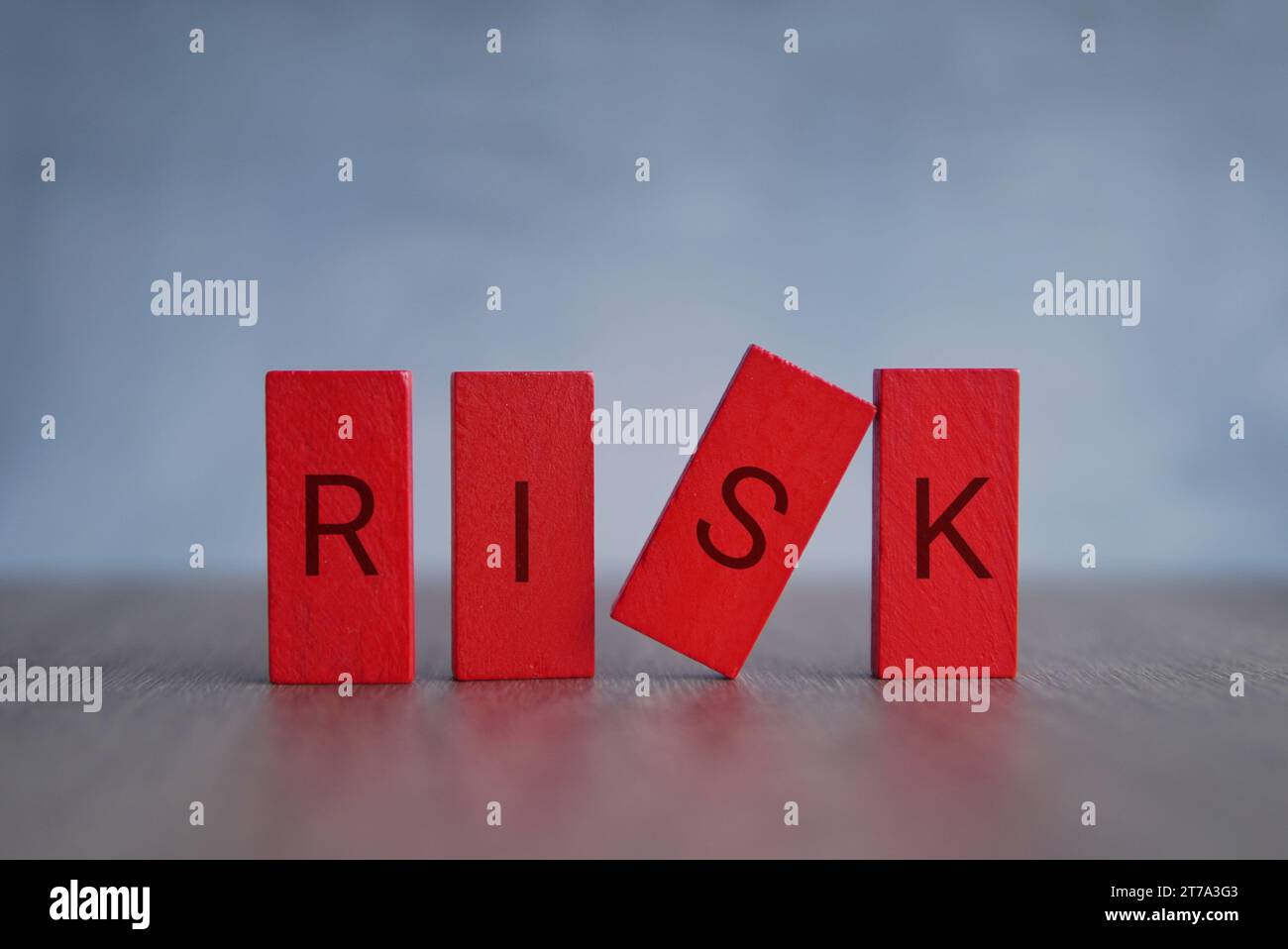 Closeup image of wooden tiles with text RISK. Business and finance ...
