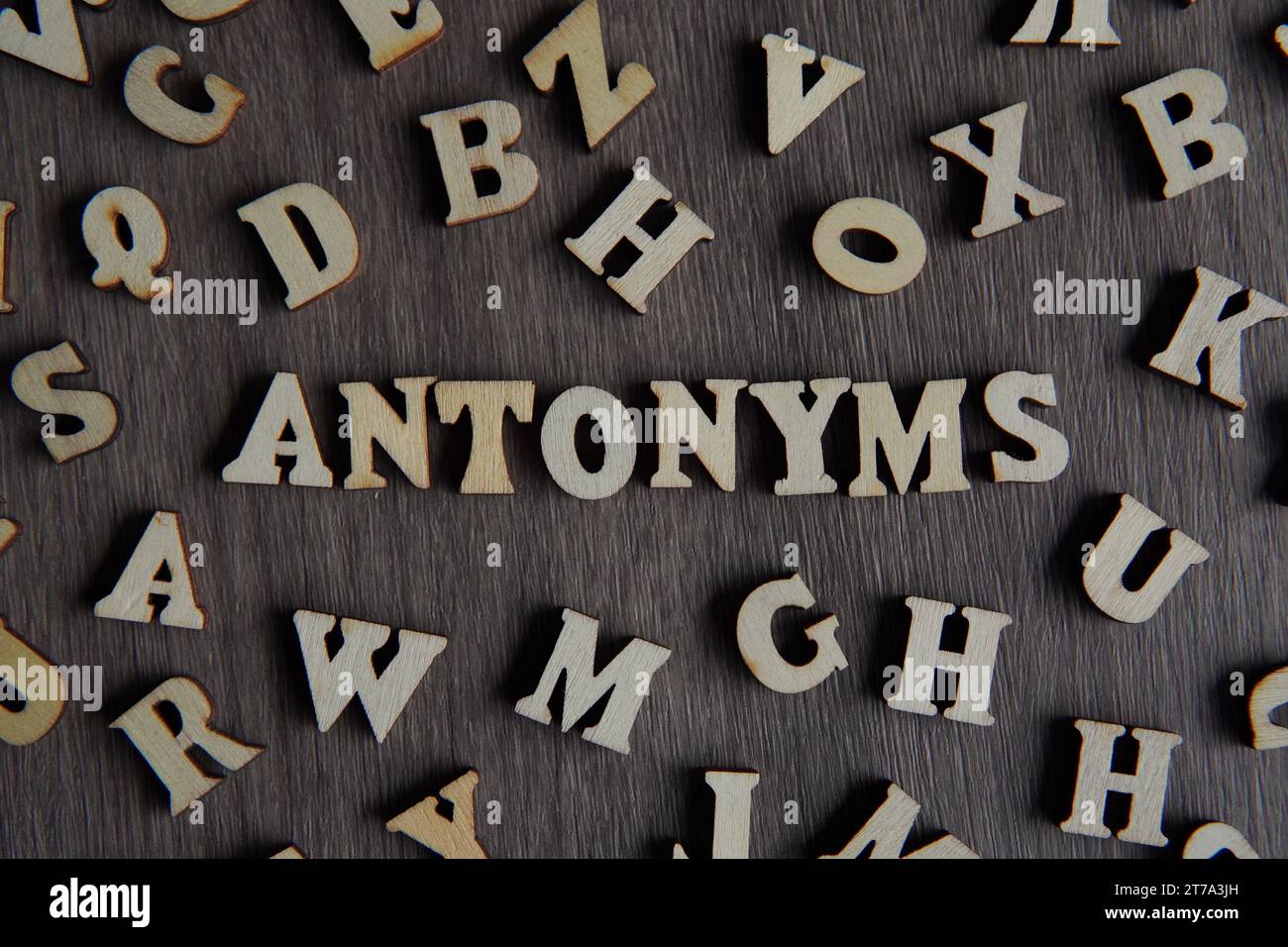Closeup image of text ANTONYMS surrounded by scattered alphabet Stock ...