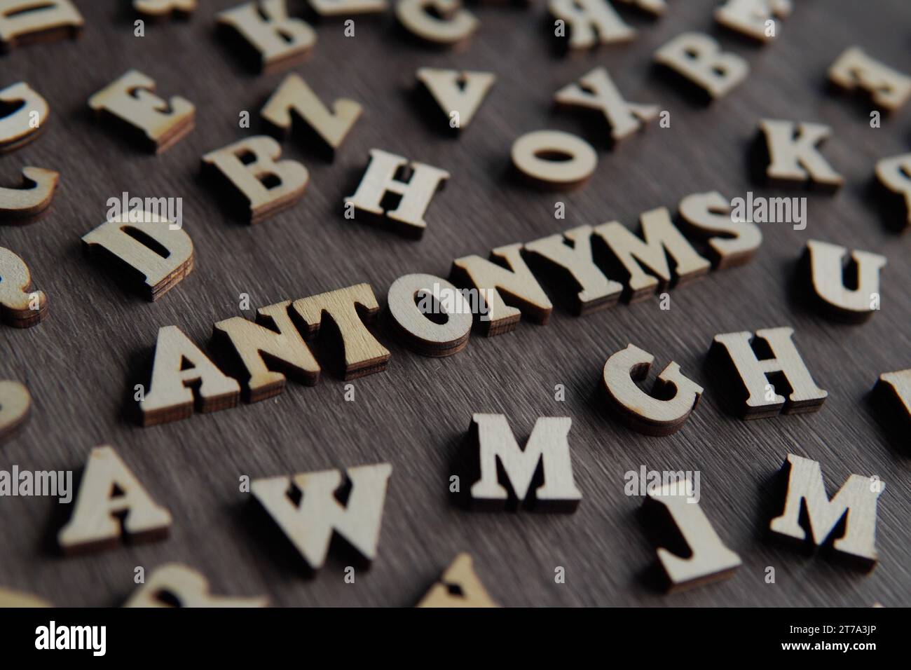 Closeup image of text ANTONYMS surrounded by scattered alphabet Stock ...