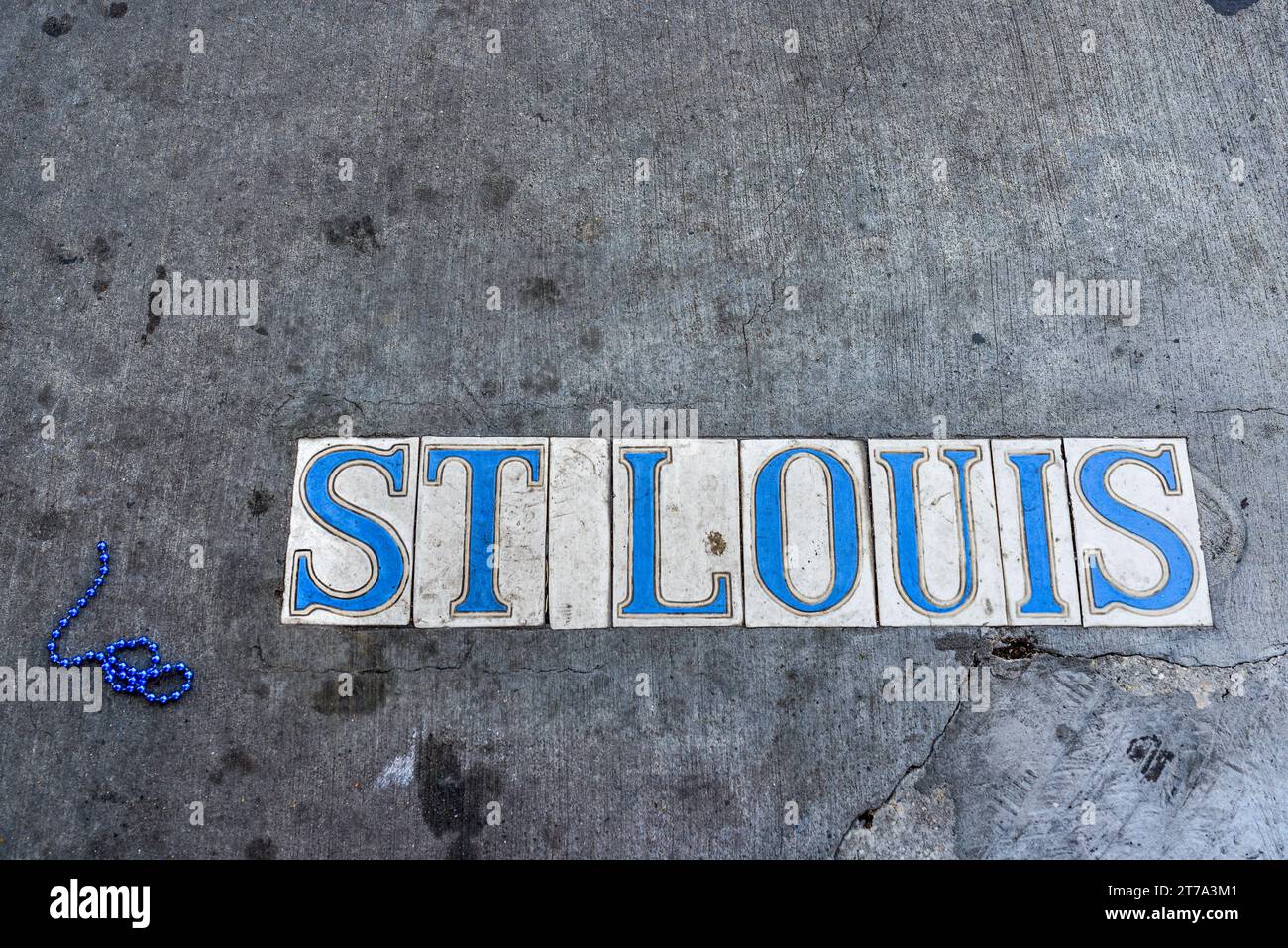 Historic St. Louis Street tile inlay on the sidewalk in the French ...
