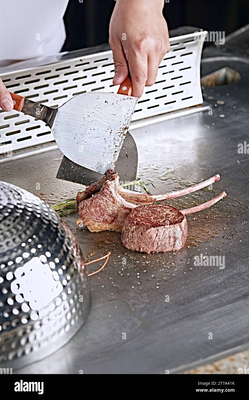 Teppanyaki， Cooking lamb chop on iron hot plate Stock Photo - Alamy