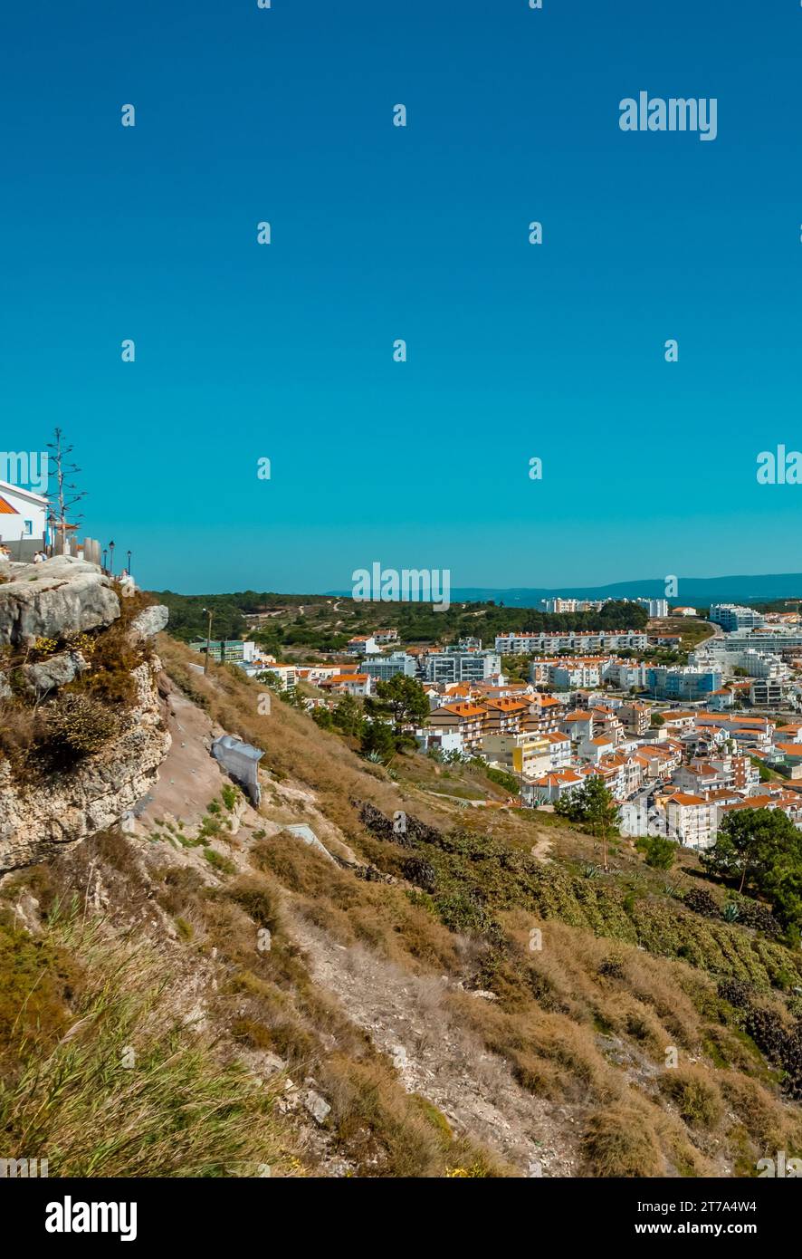 A coastal town with colorful terracotta rooftops and a tranquil azure ...