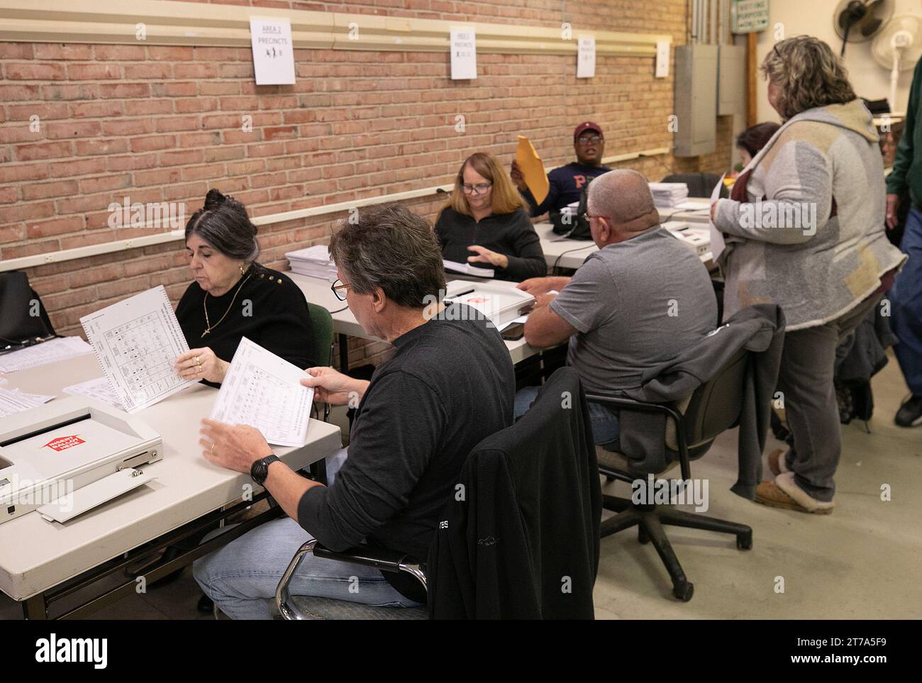 Counters check over ballots during a vote recount at the ballot holding ...